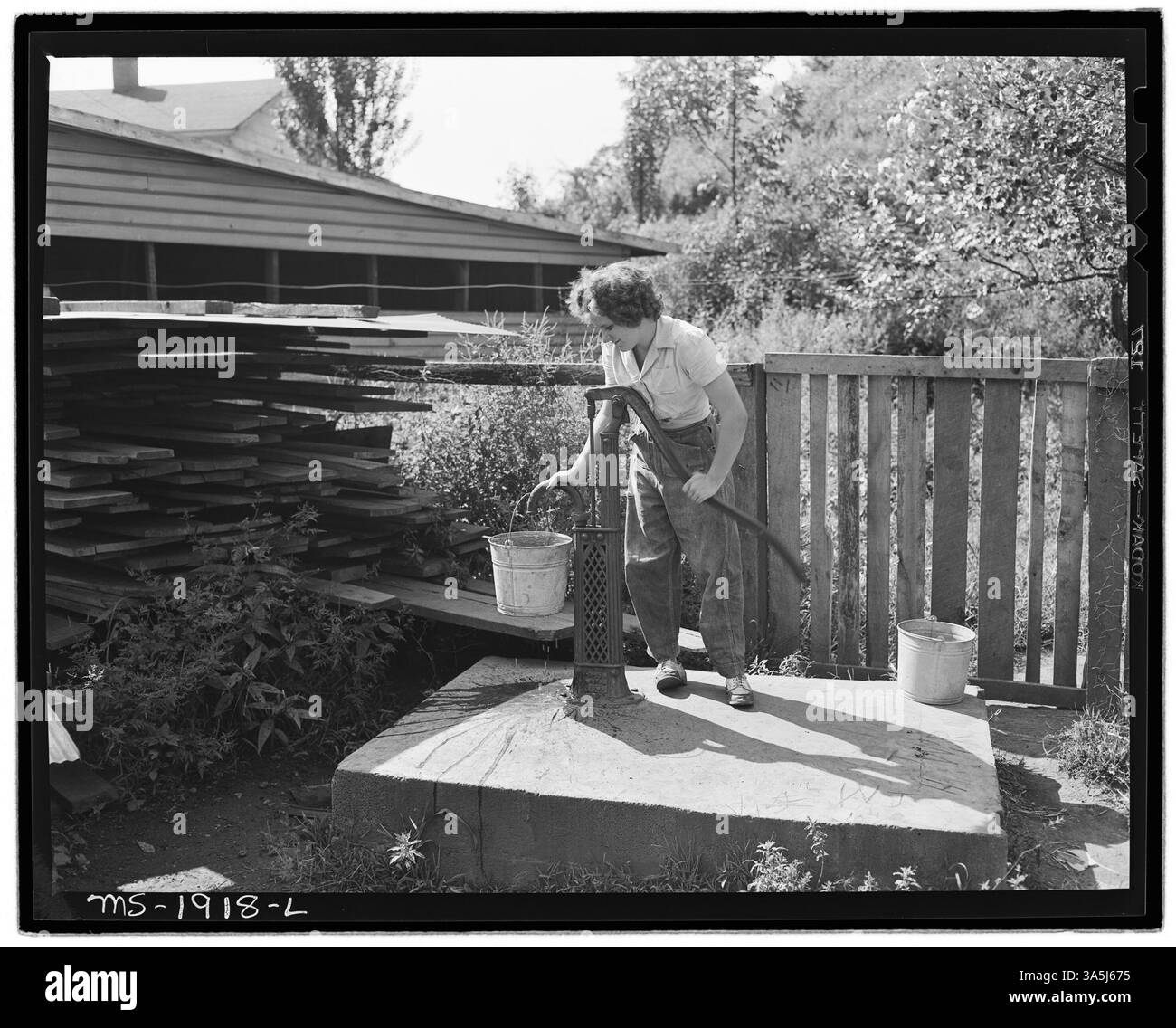Two pumps, located at either end of a row of houses, provide drinking ...