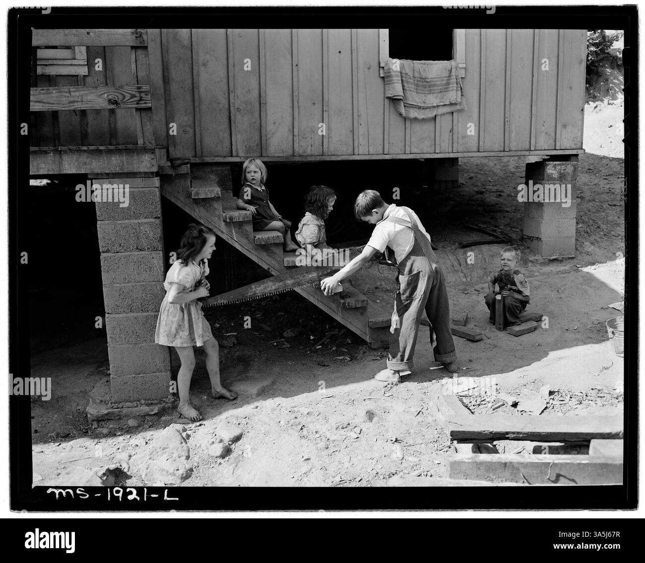 The image shows children playing near houses that have been lifted and ...