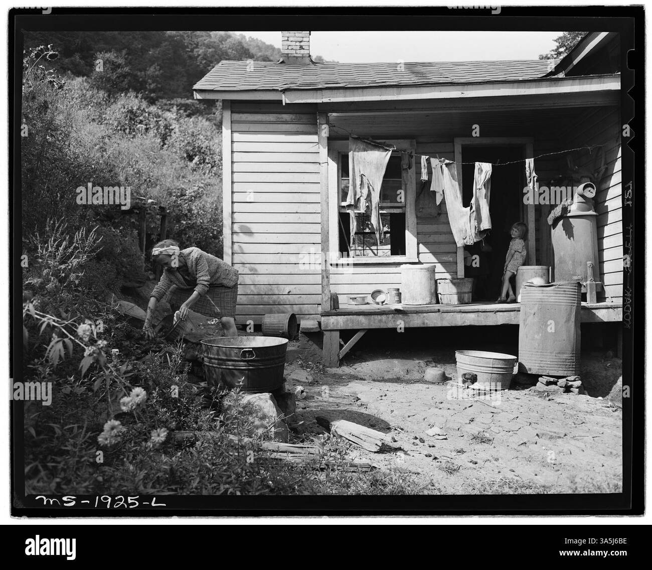 Mrs. Bill Daniels, a miner’s wife, collects coal for her kitchen stove ...