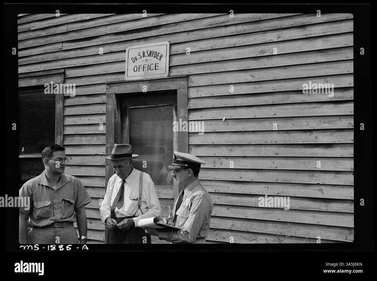 A 1946 image of Dr. Faulkner, Dr. Snyder, and Comdr. Philbrook standing ...