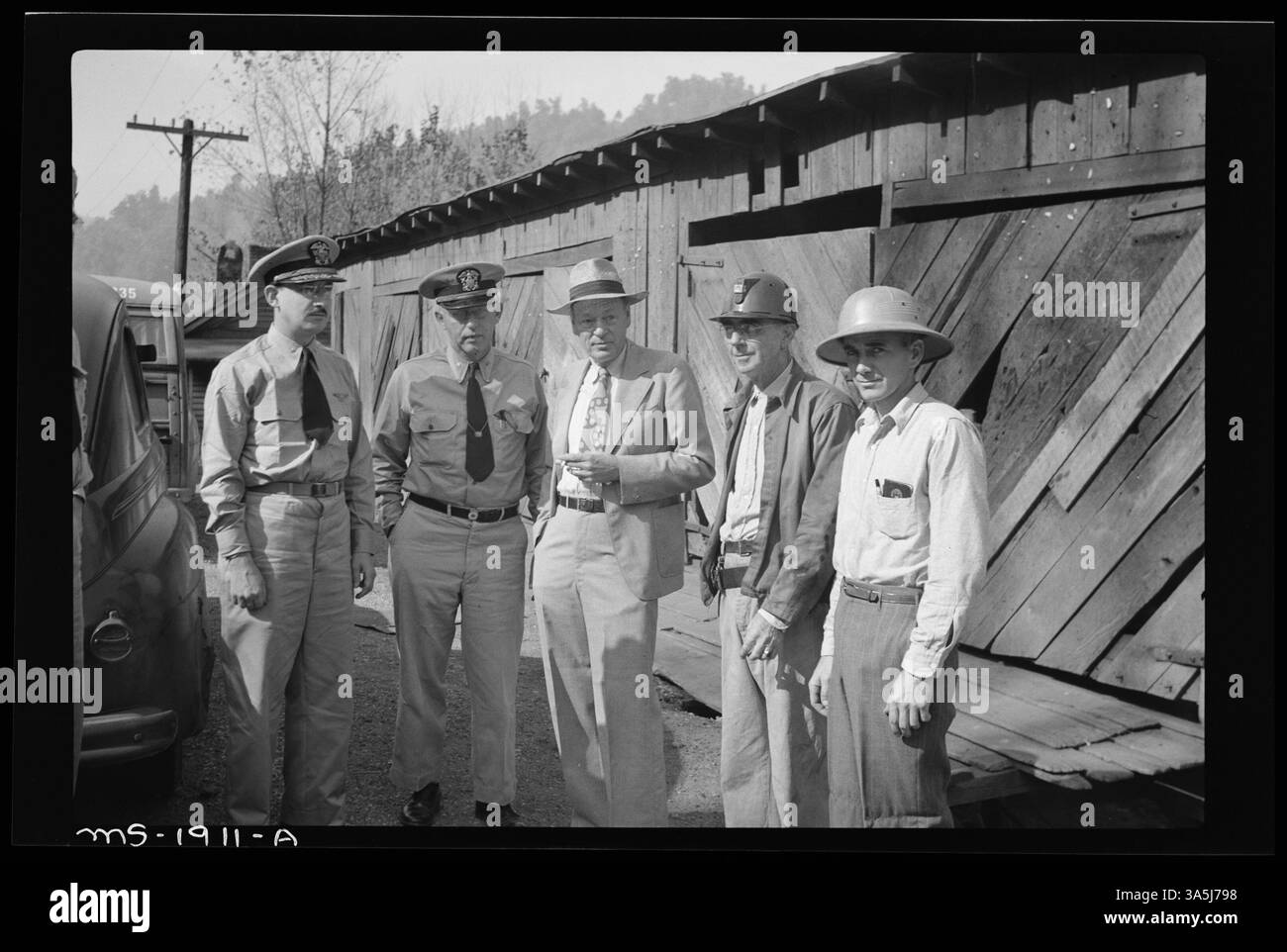 A group of individuals, including Comdr. Philbrook, Lt. Comdr. Wright ...