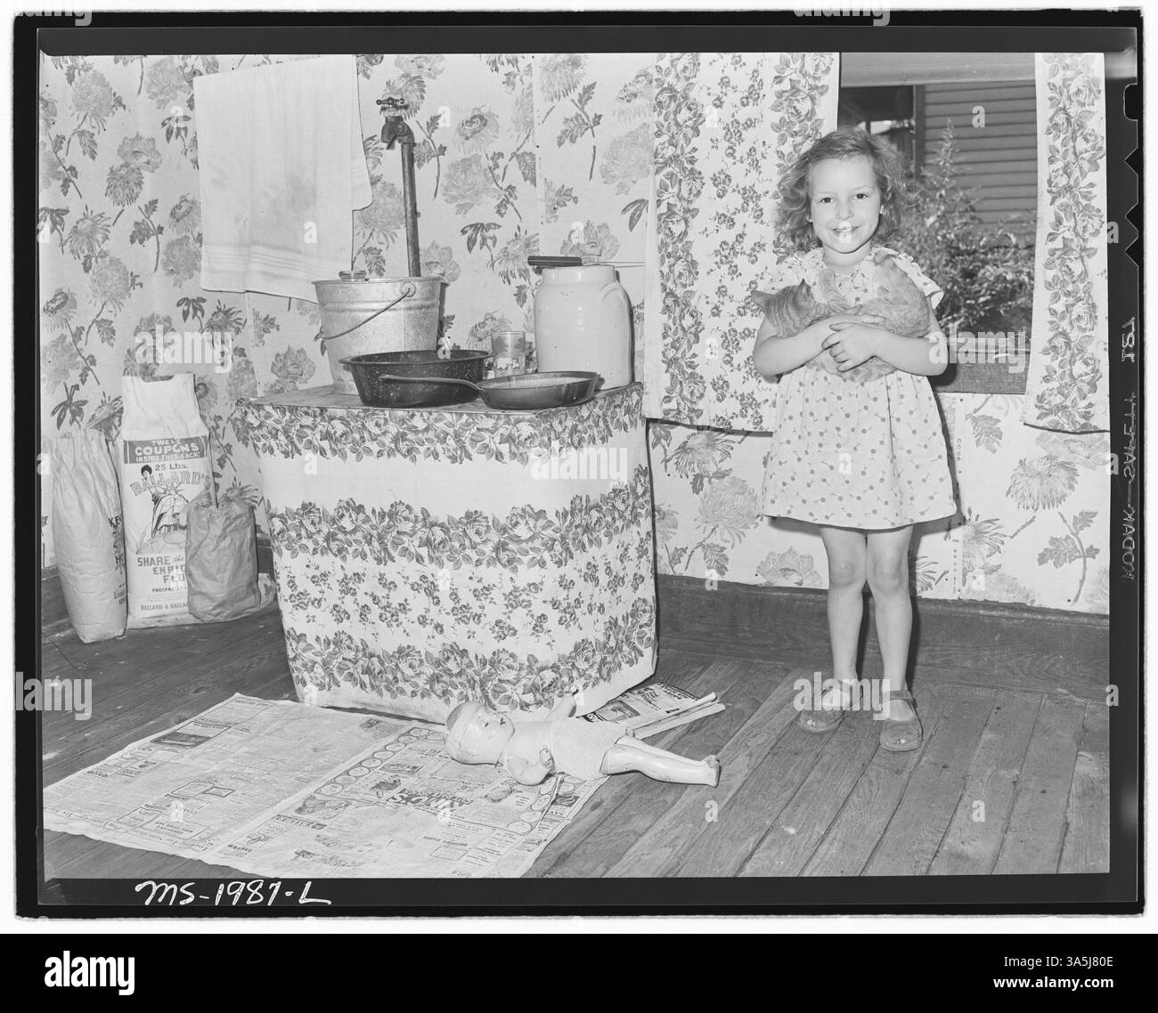 The daughter of Lewis Moncy, a miner, is shown in her kitchen at the ...