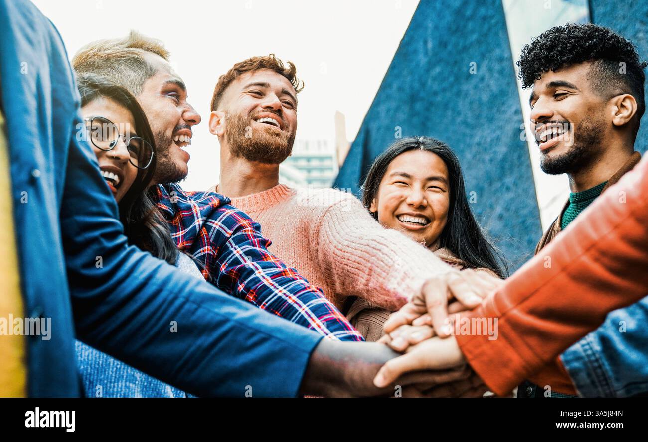 Group of people stacking hands, celebrating together. Diverse friends ...