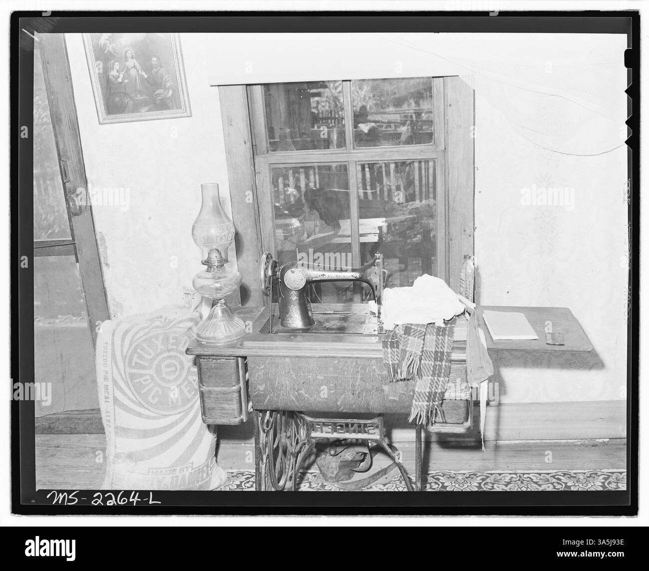 A photograph of a sewing machine and kerosene lamp in a miner’s home ...