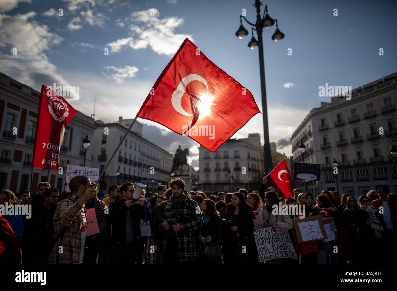 Madrid, Spain. March 23, 2025. Turkish protesters carry their national ...