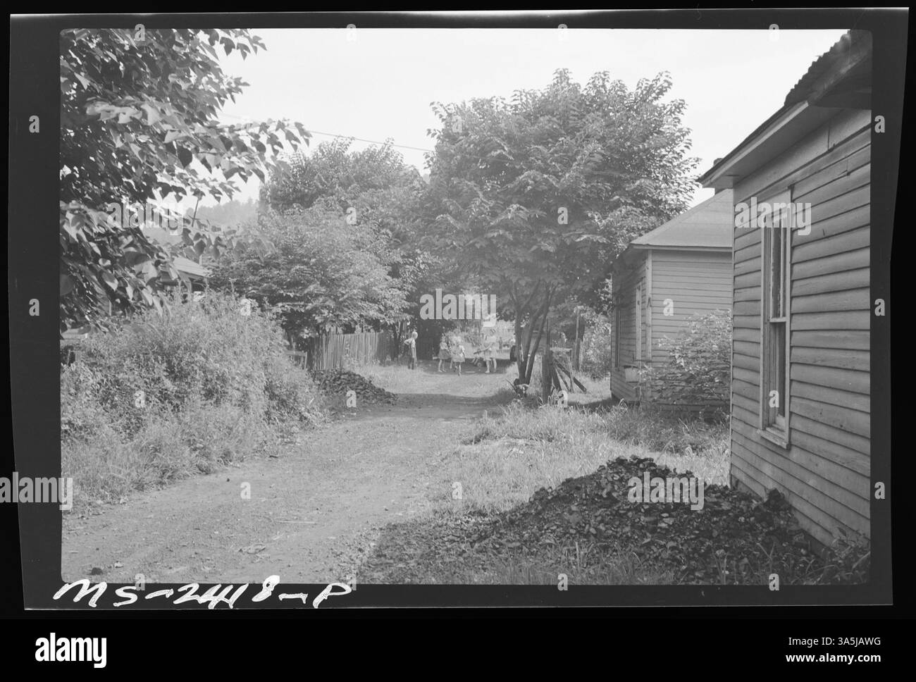This image depicts children playing in a playground behind House #3 at ...
