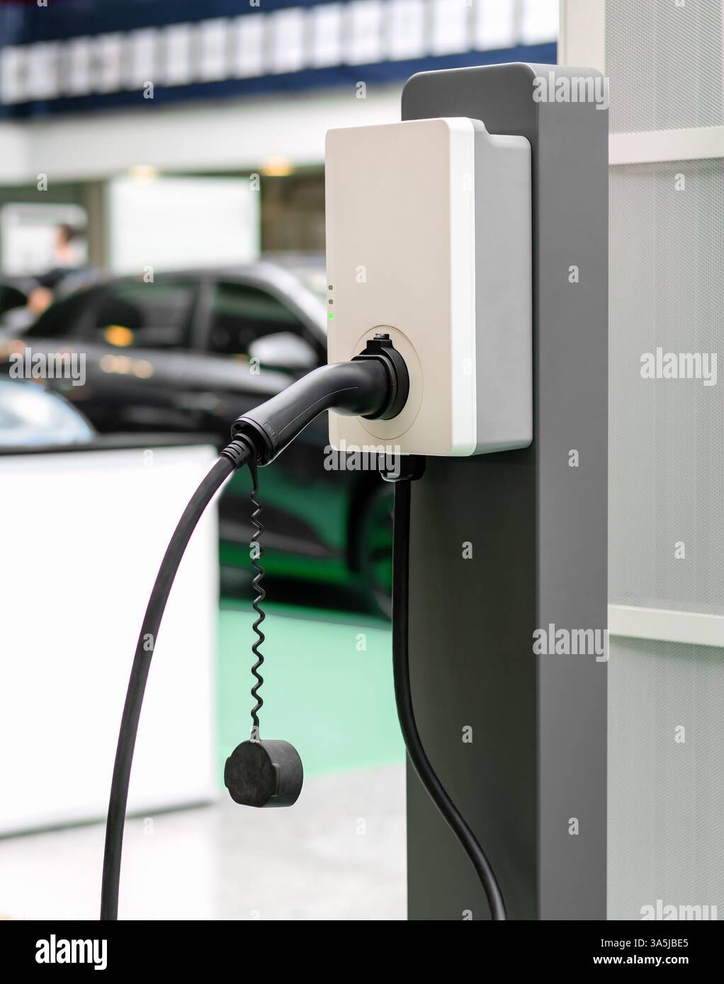Electric vehicle charging station in underground parking Stock Photo ...