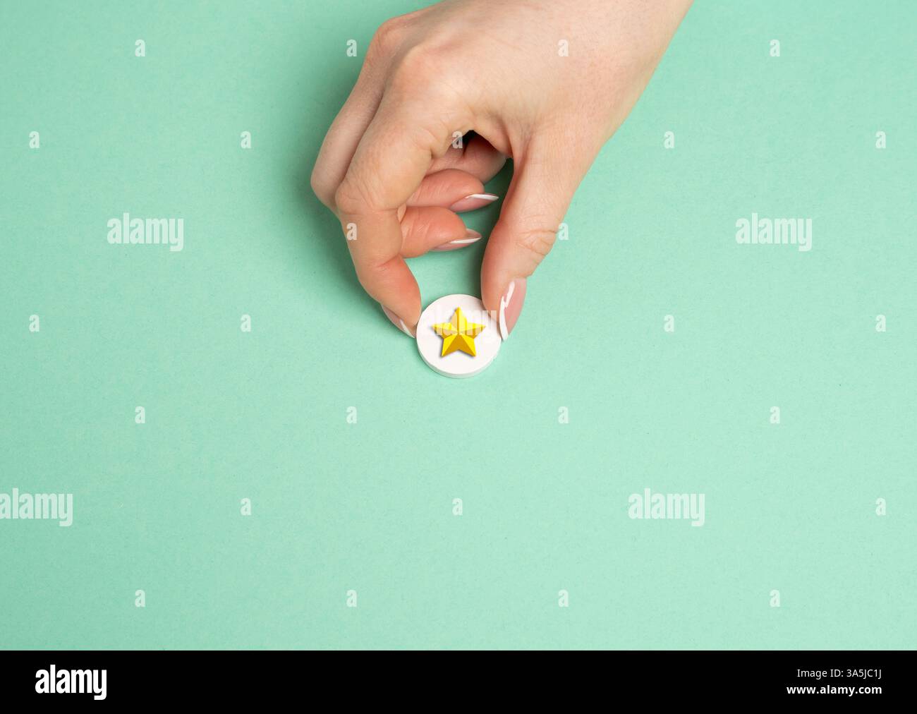 The hand holds a gold star. Distinction. Rating and recognition ...