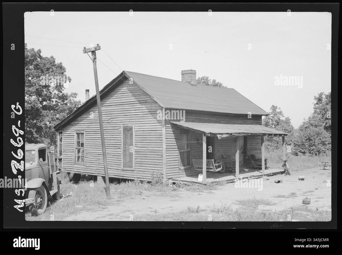 A photograph shows a house in a mining community, capturing the ...