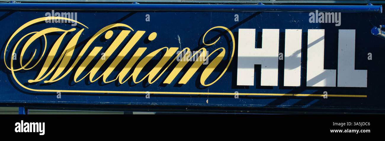 Signage displaying "William HILL" in yellow cursive and white block ...