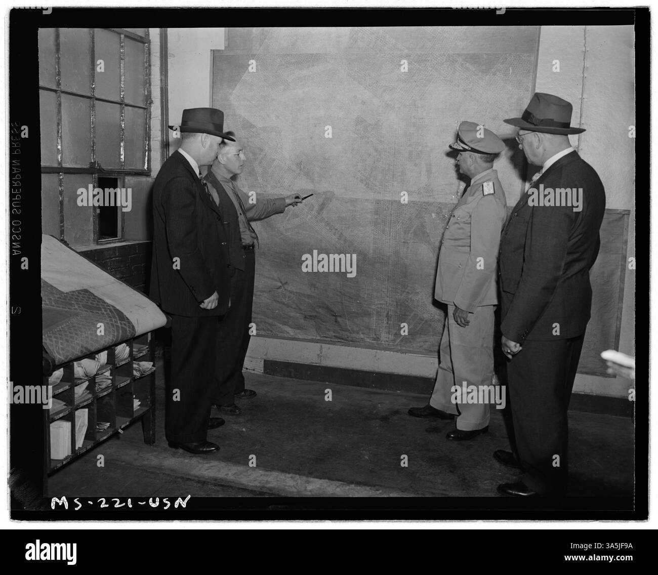 Admiral Boone examines a map of the Nemacolin Mine while accompanied by ...