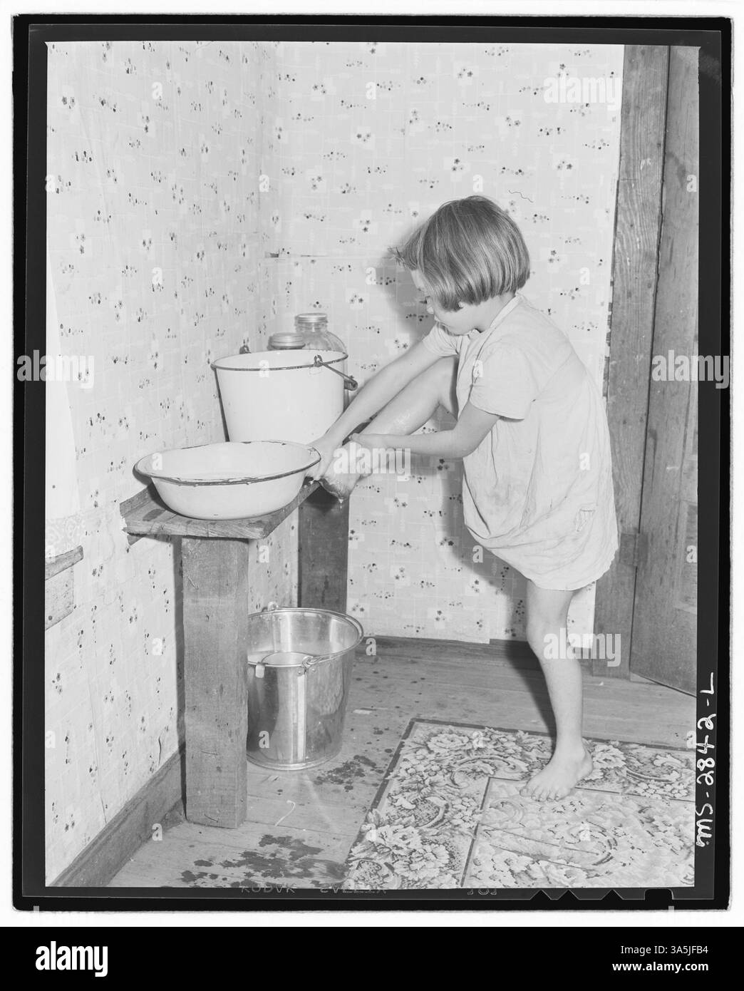 Wanda Lee, a child in Lejunior, Kentucky, washes her feet before going ...