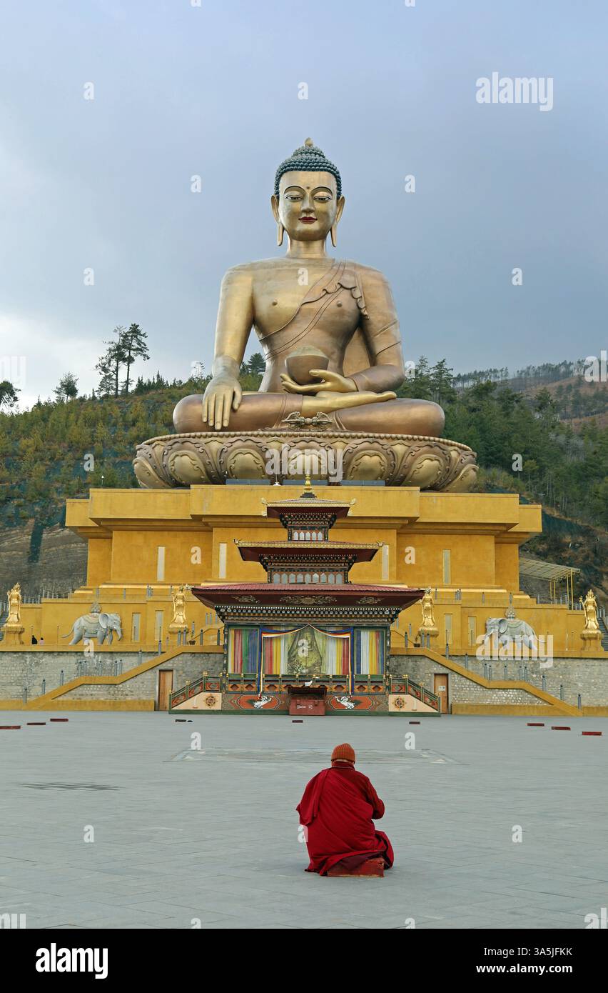 Monk praying at Buddha Point in Bhutan Stock Photo - Alamy