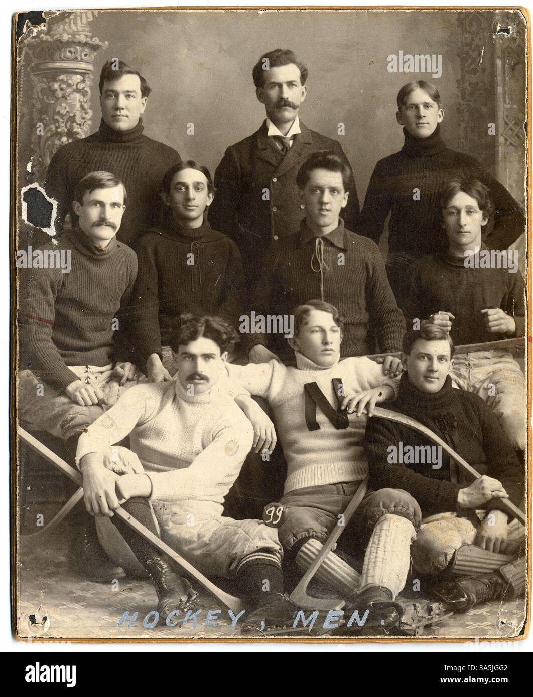 The St. Cloud State University men's hockey team is shown in a group portrait, with one player ...