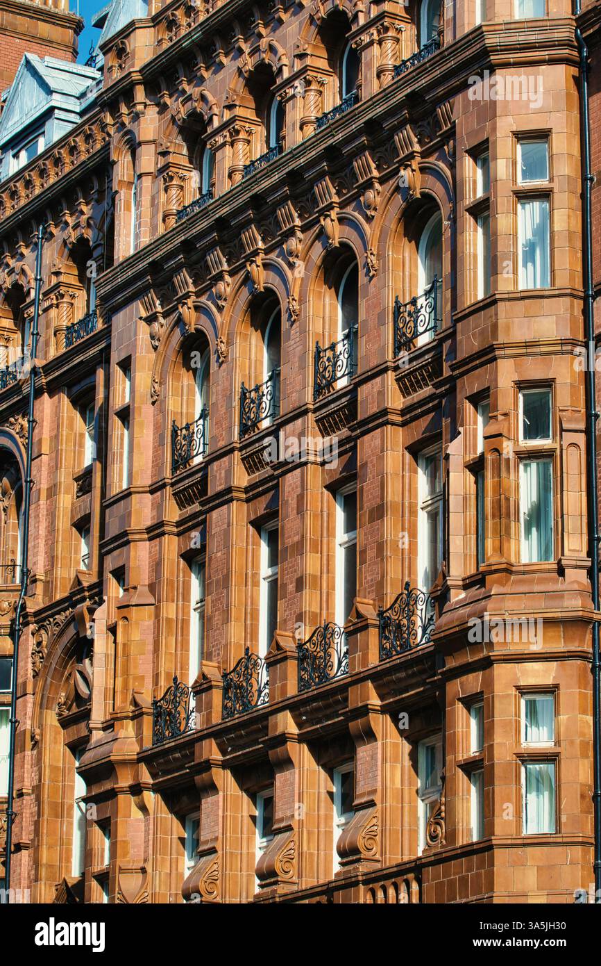 A detailed architectural view showcases a brown stone building facade ...