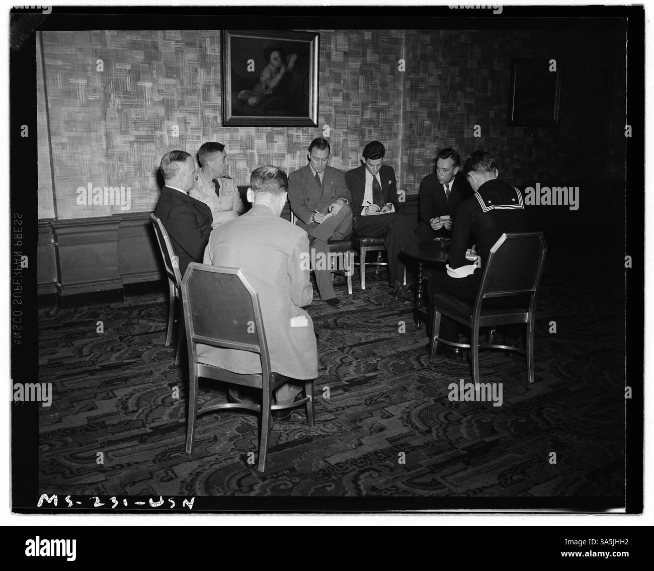 A photograph from a press conference featuring Rear Admiral Joel T ...