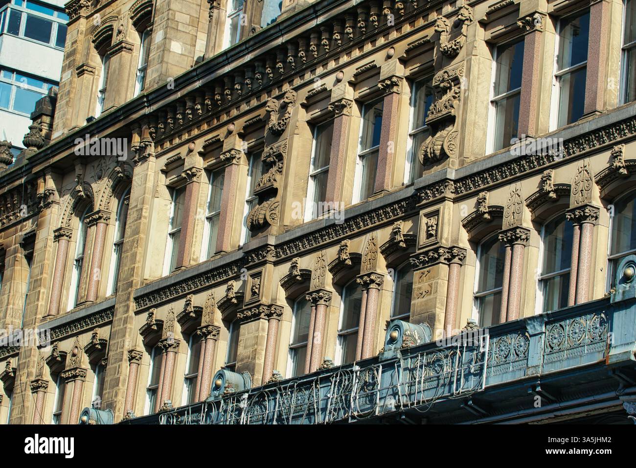 Detailed facade of a building with ornate stonework, multiple windows ...