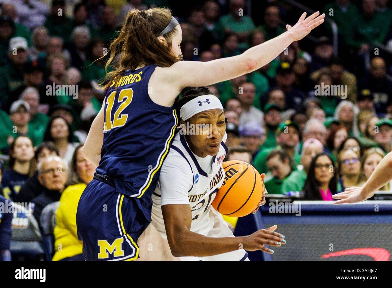 Notre Dame forward Liatu King (20) drives around Michigan guard Syla ...