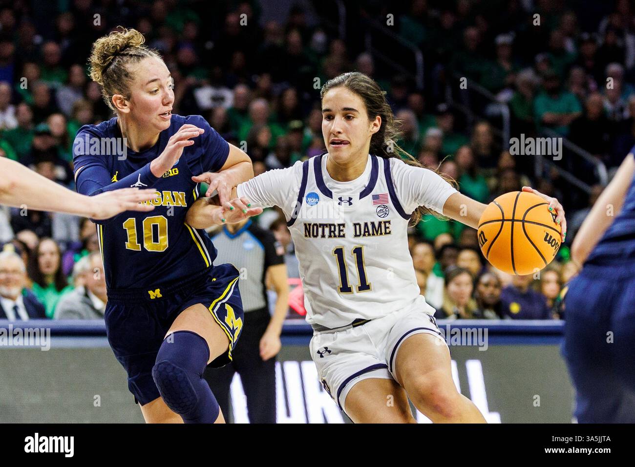 Notre Dame guard Sonia Citron (11) drives around Michigan guard Jordan ...