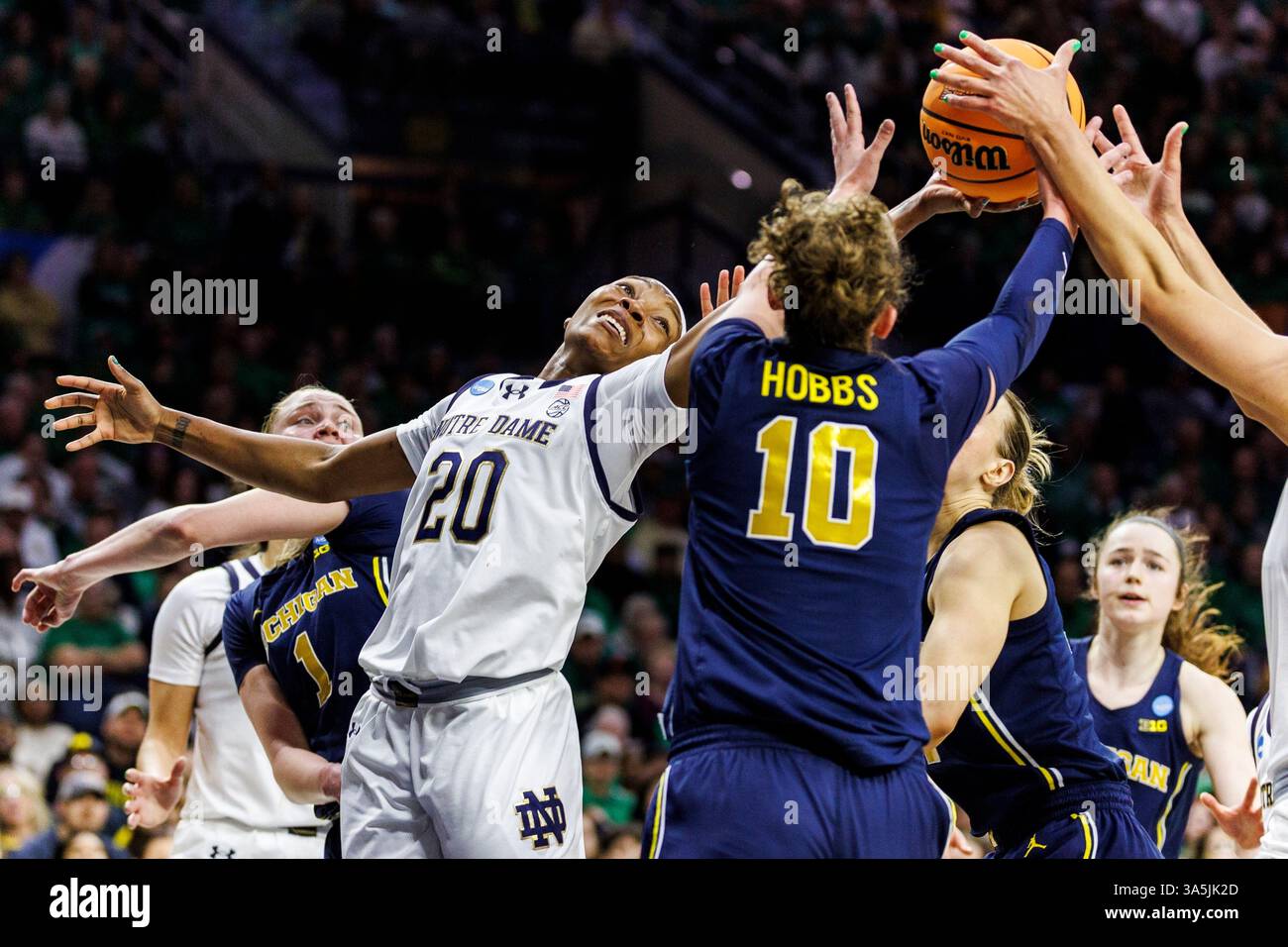 Notre Dame forward Liatu King (20) and Michigan guard Jordan Hobbs (10 ...