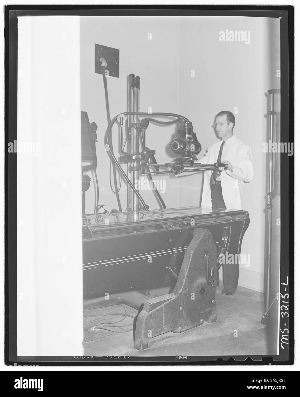 A laboratory technician operates an X-ray machine at a company-owned ...