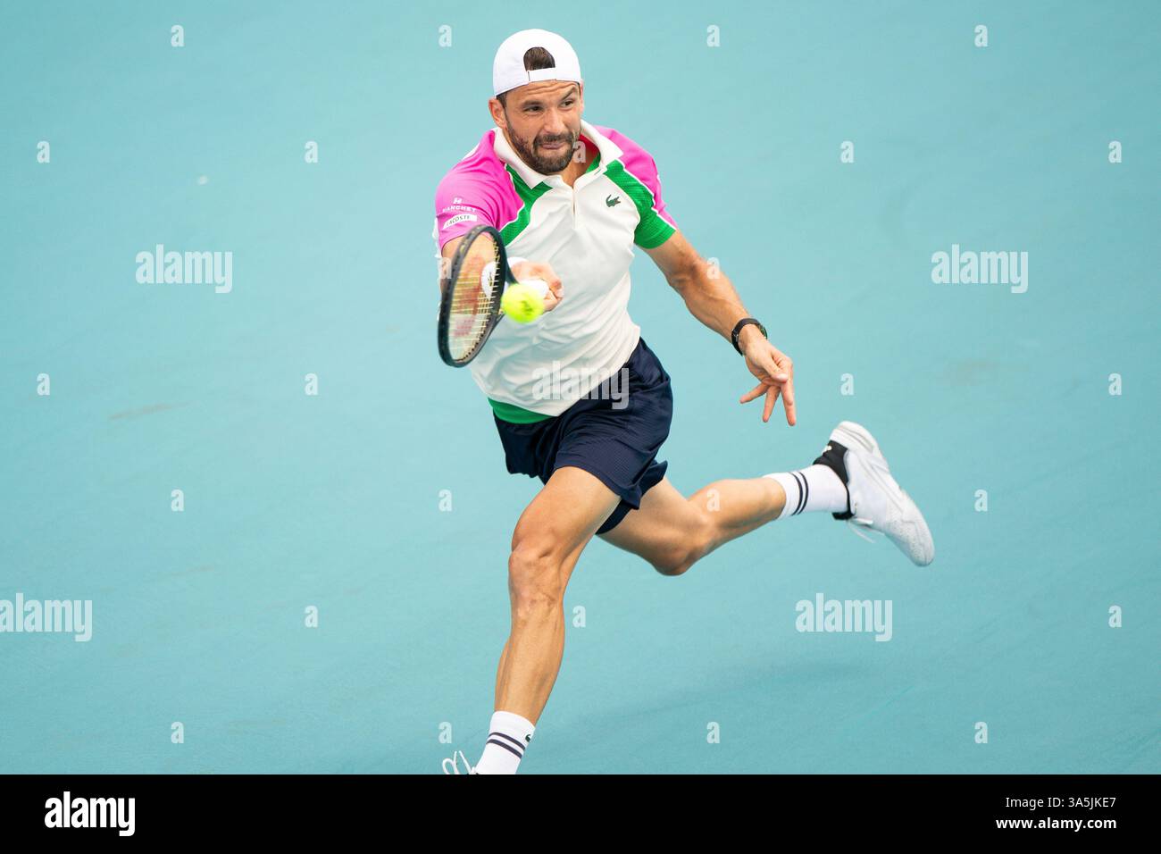 Grigor Dimitrov of Bulgaria returns the ball during the Miami Open ...