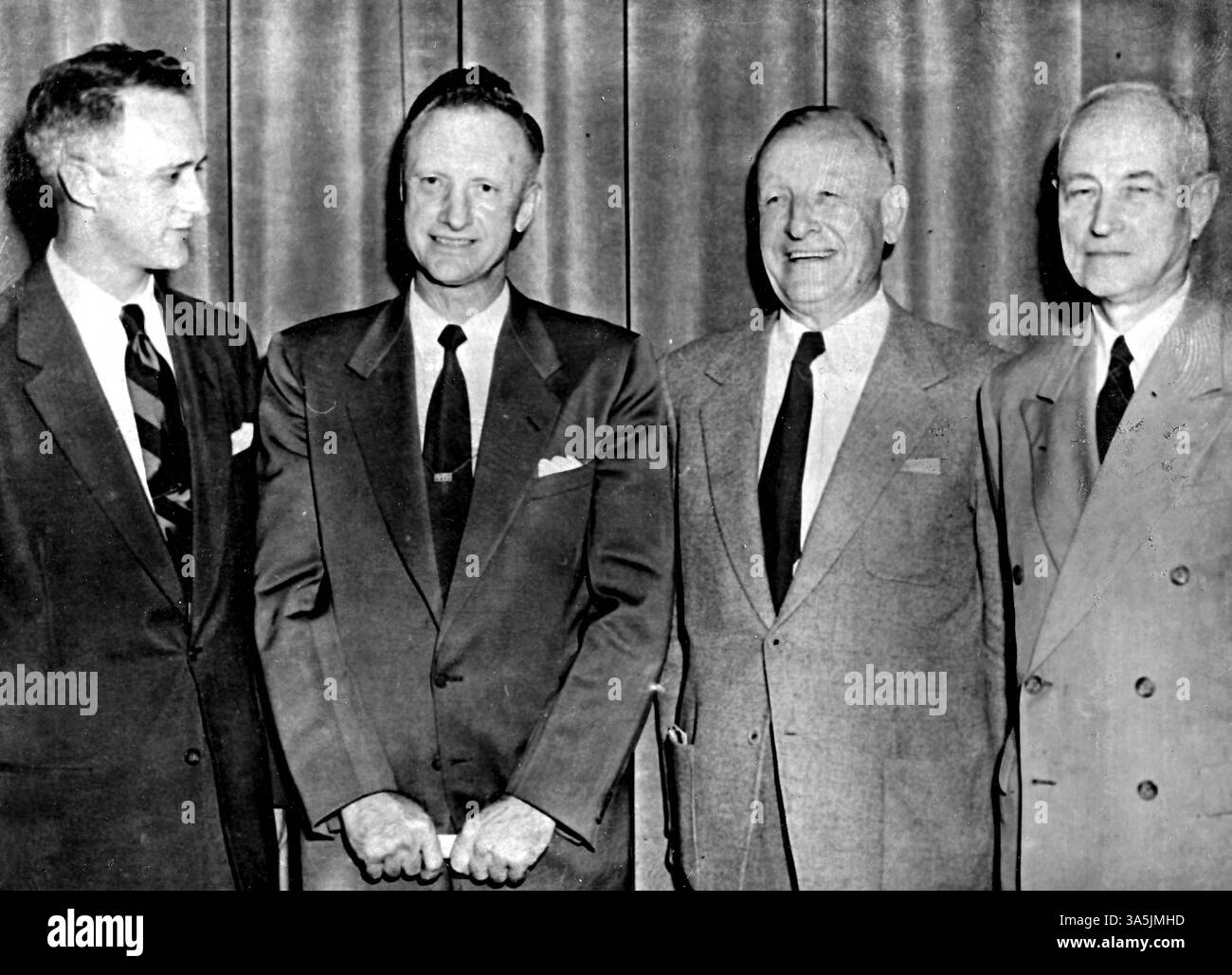 A black-and-white photo of George Budd, John Headley, George Selke, and ...