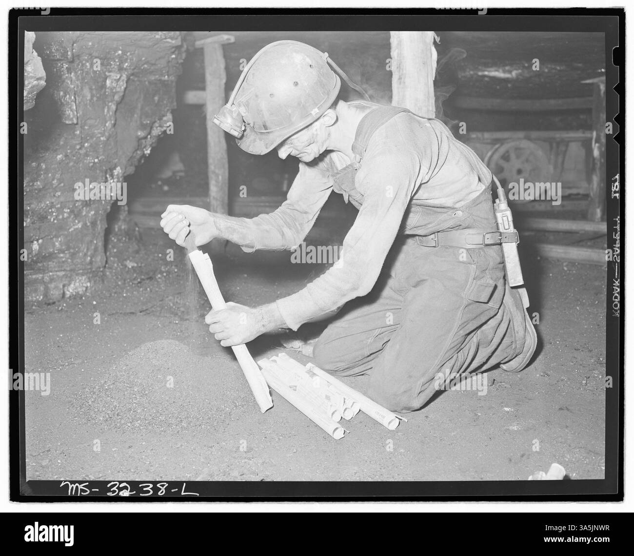 Coal loader Harry Fain prepares 'stemmings' used for the proper ...