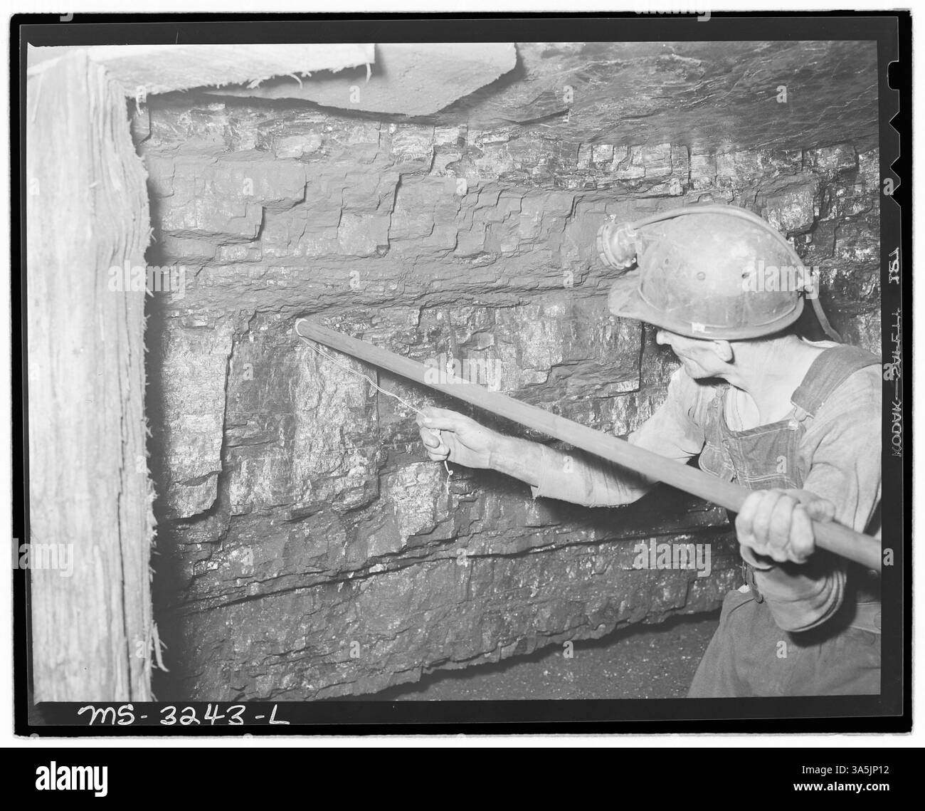Harry Fain, a coal loader at Inland Steel Company’s Wheelwright Mine, prepares a powder charge ...