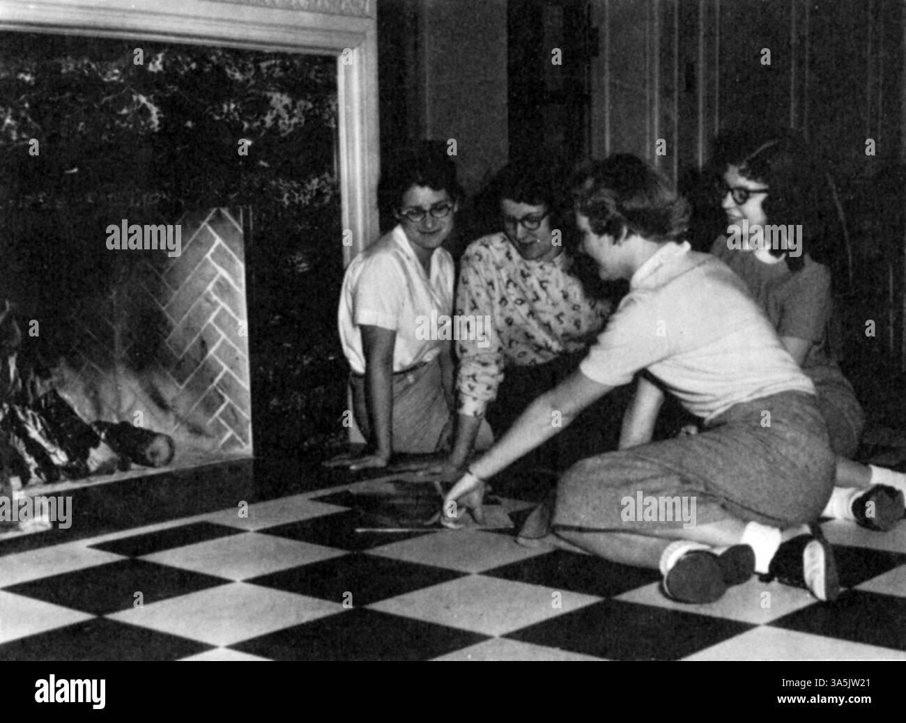 A group of residents sit by the fireplace in the Whitney House at St ...