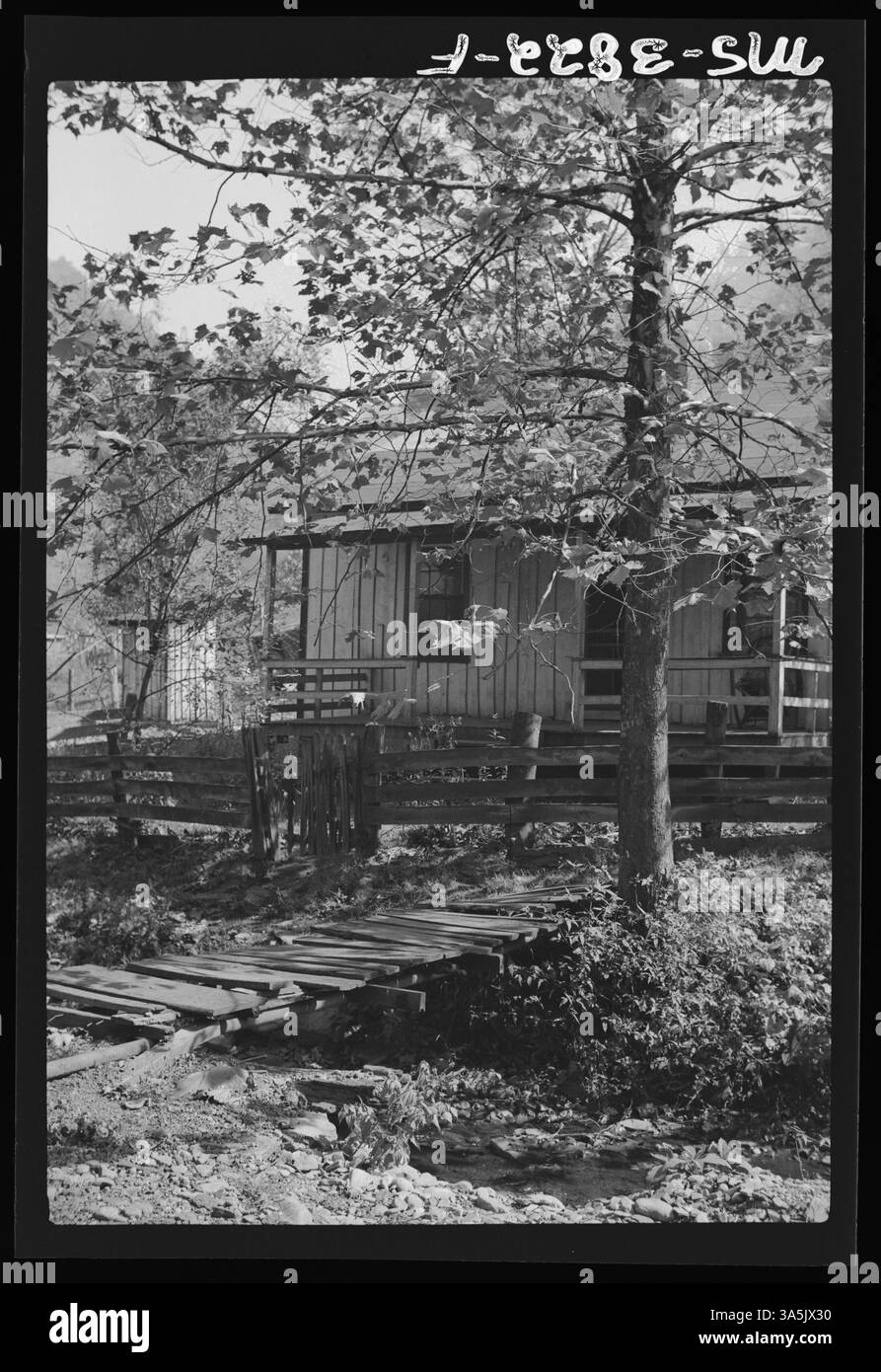 This photograph depicts a rickety footbridge over a stream at the Wymar ...