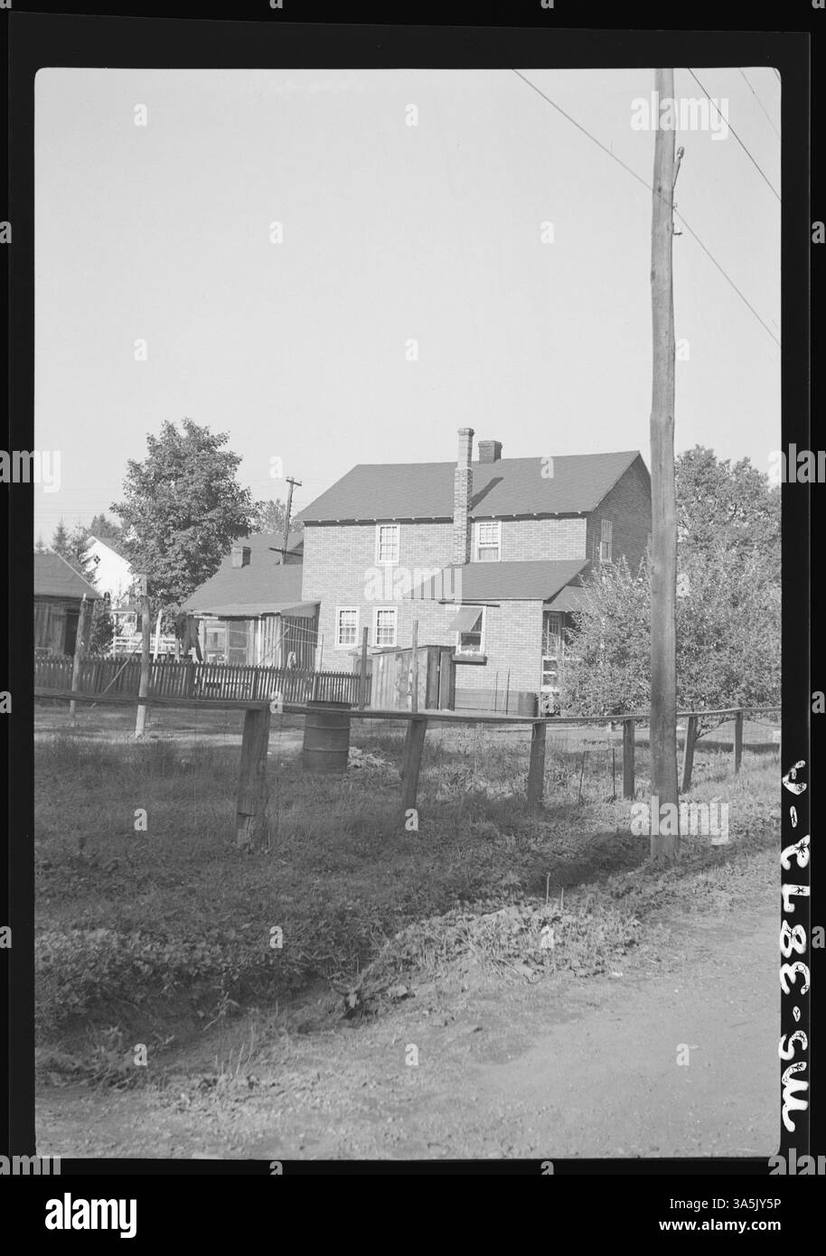 A photograph depicting a house within a mining community, reflecting ...