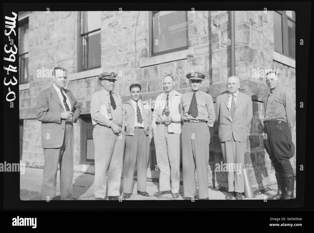 Members of a medical survey group are shown with workers in Revloc ...