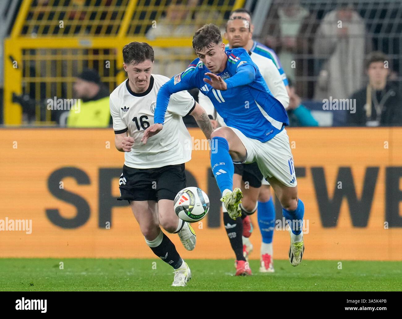 Daniel Maldini (Italy, #11) moves the ball past Angelo Stiller (Germany ...