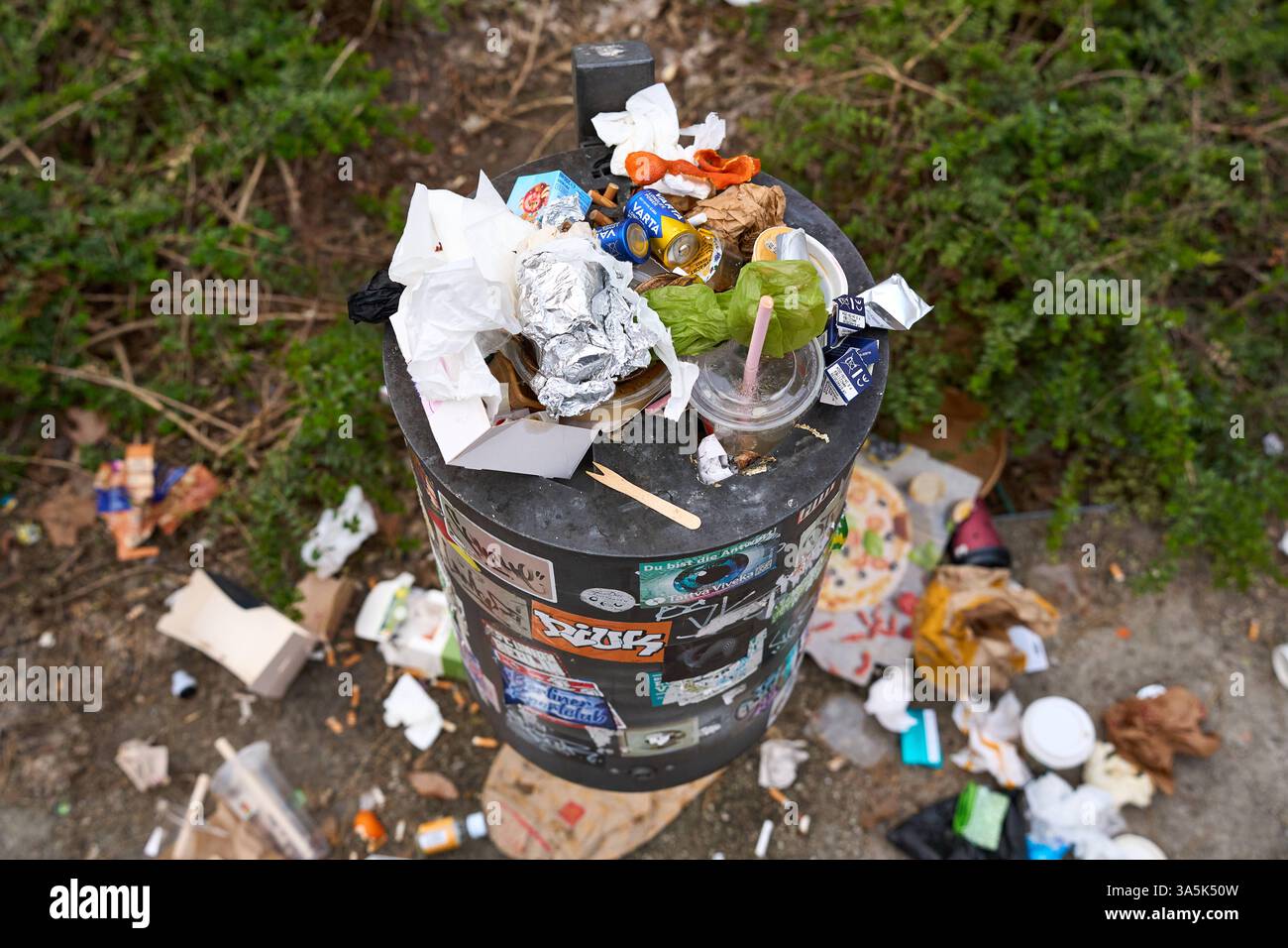 Berlin, Germany - March 23, 2025: An overflowing trash can in Berlin ...