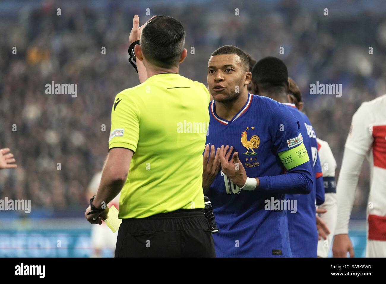 France's Kylian Mbappe protests to referee Michael Oliver after ...