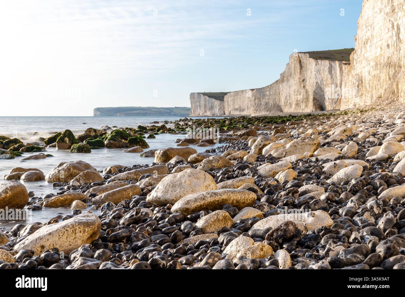 Chalk and flint boulders on the beach at Birling Gap, with the Seven ...