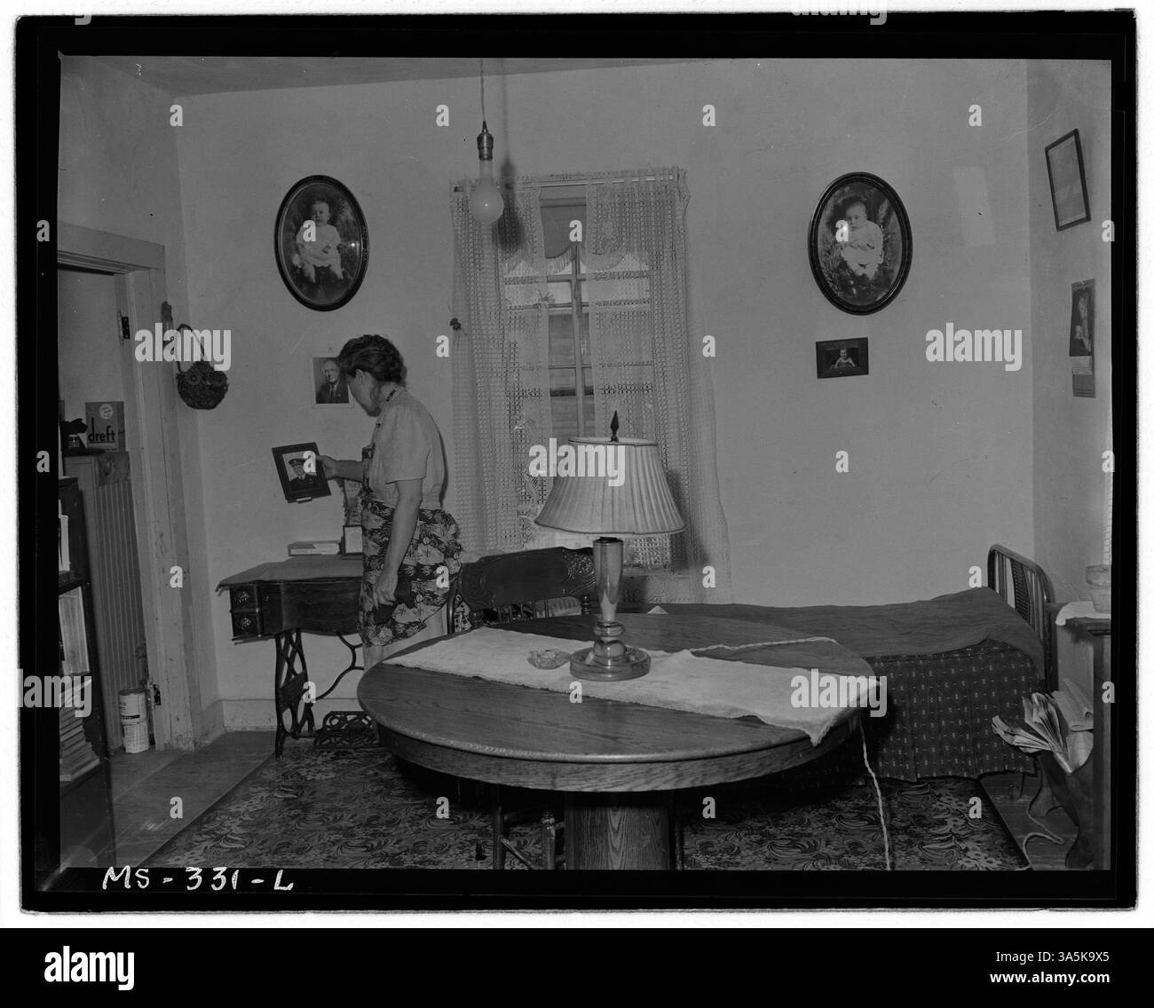 Mrs. Molly Genoff, the wife of a miner, is pictured in the living room ...