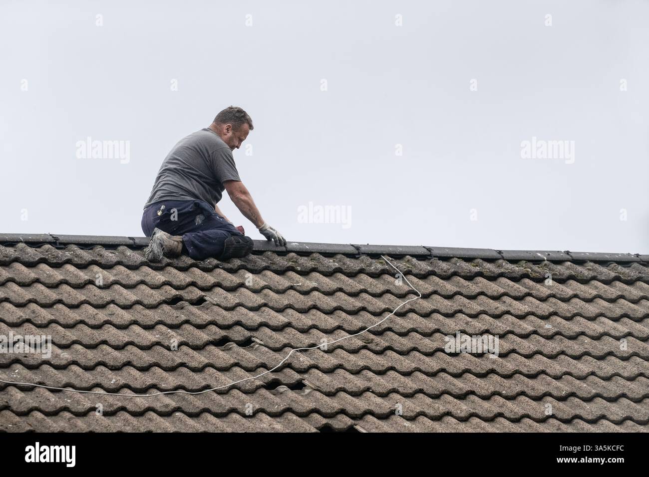Sitting astride roof hi-res stock photography and images - Alamy