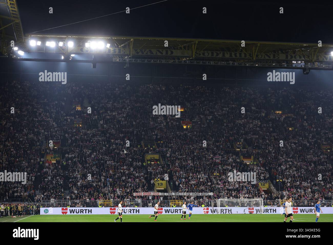Dortmund, Germany. 23rd Mar, 2025. Fans display a banner against the ...