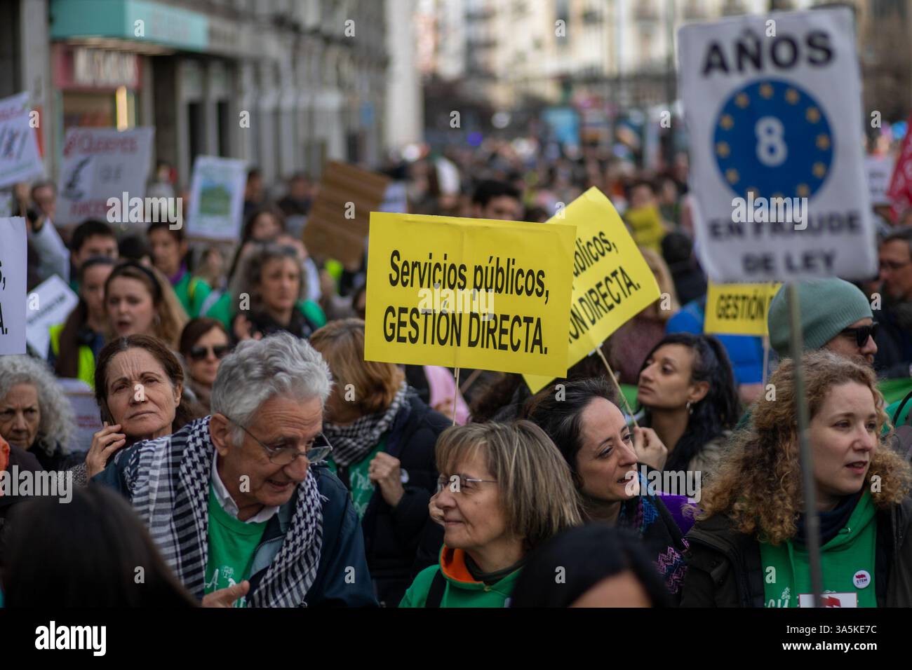 Protesters hold placards during a demonstration in defense of public ...