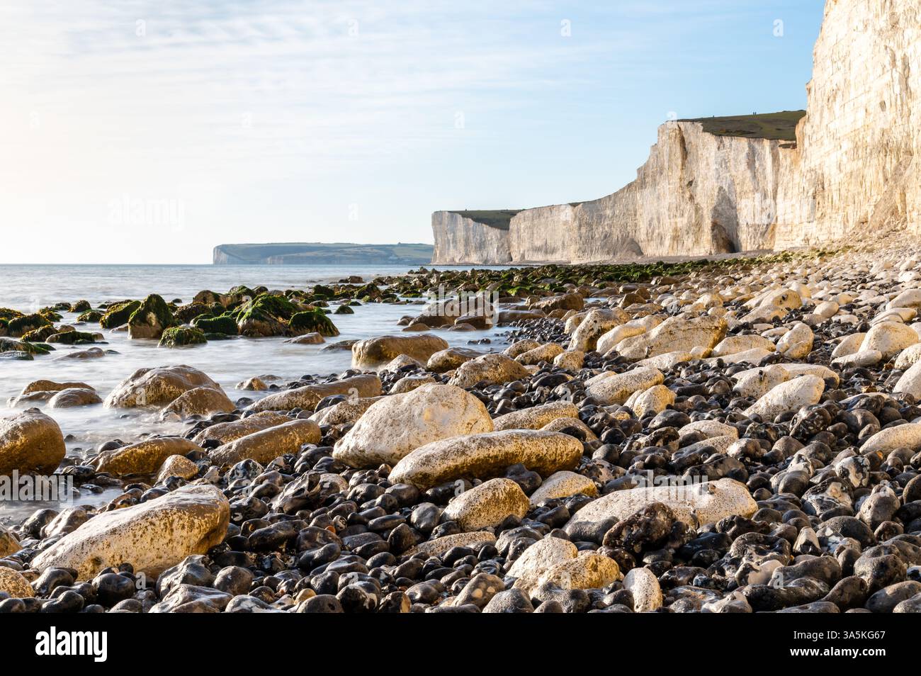 Chalk boulders on the shore at Birling Gap, with the Seven Sisters ...