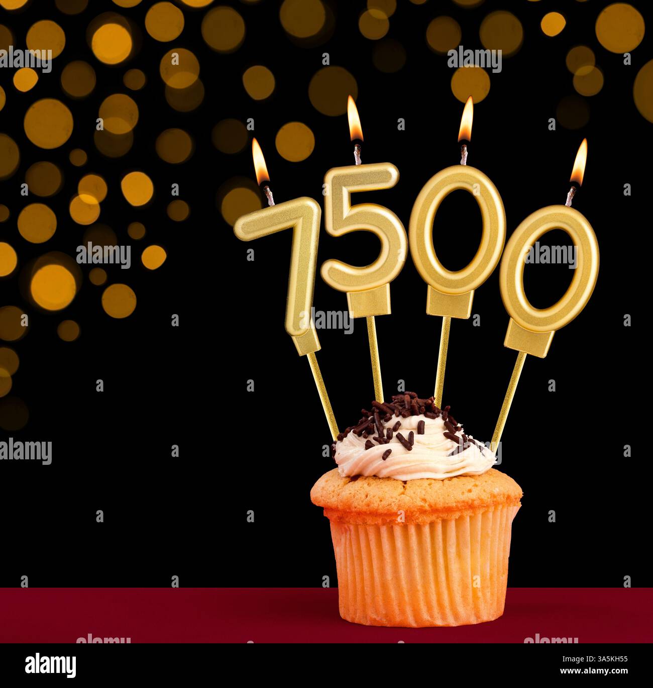 Birthday candle with cupcake - Number 7500 on black background with out ...