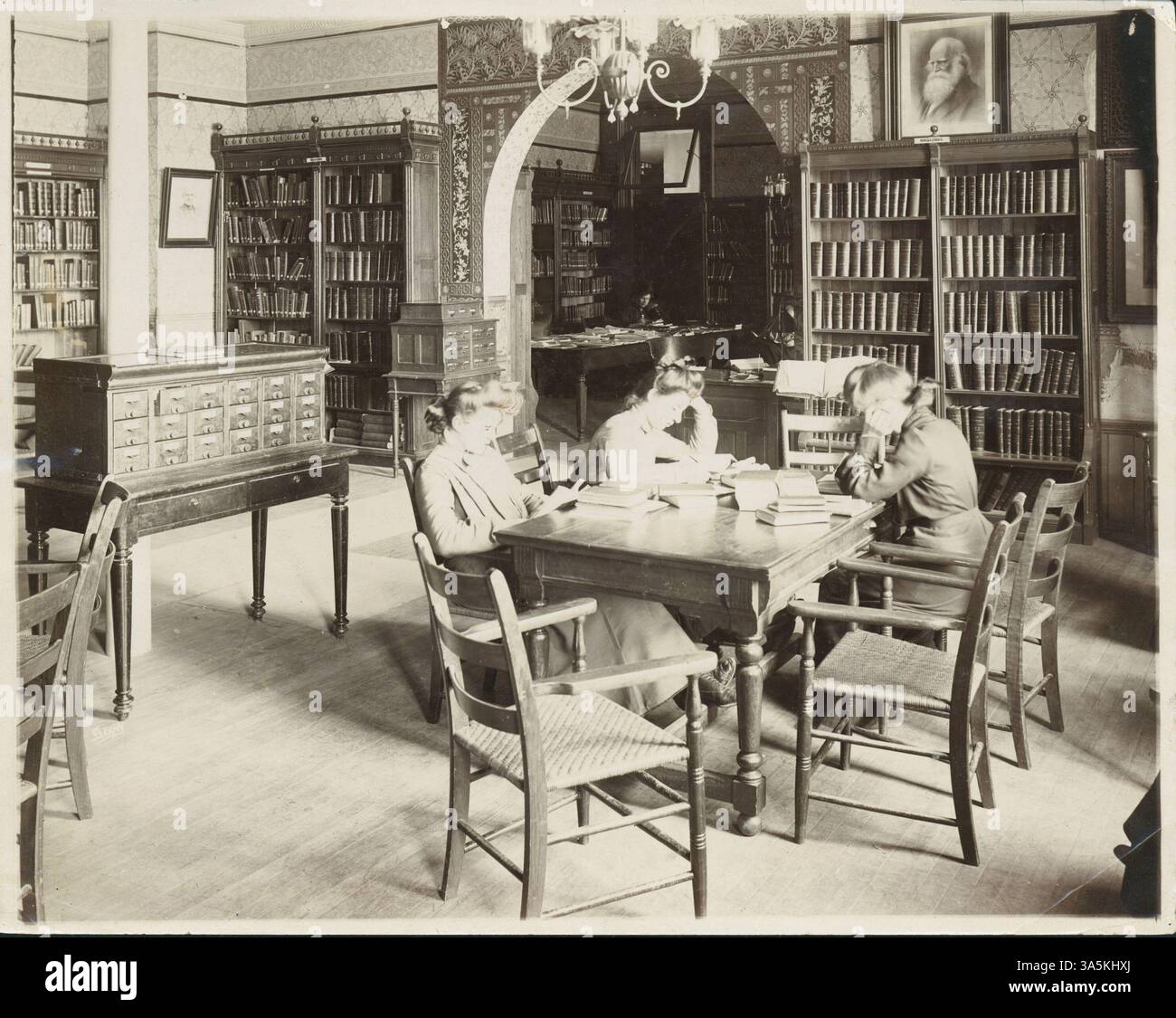 This historical photo shows three female students studying in th hi-res ...