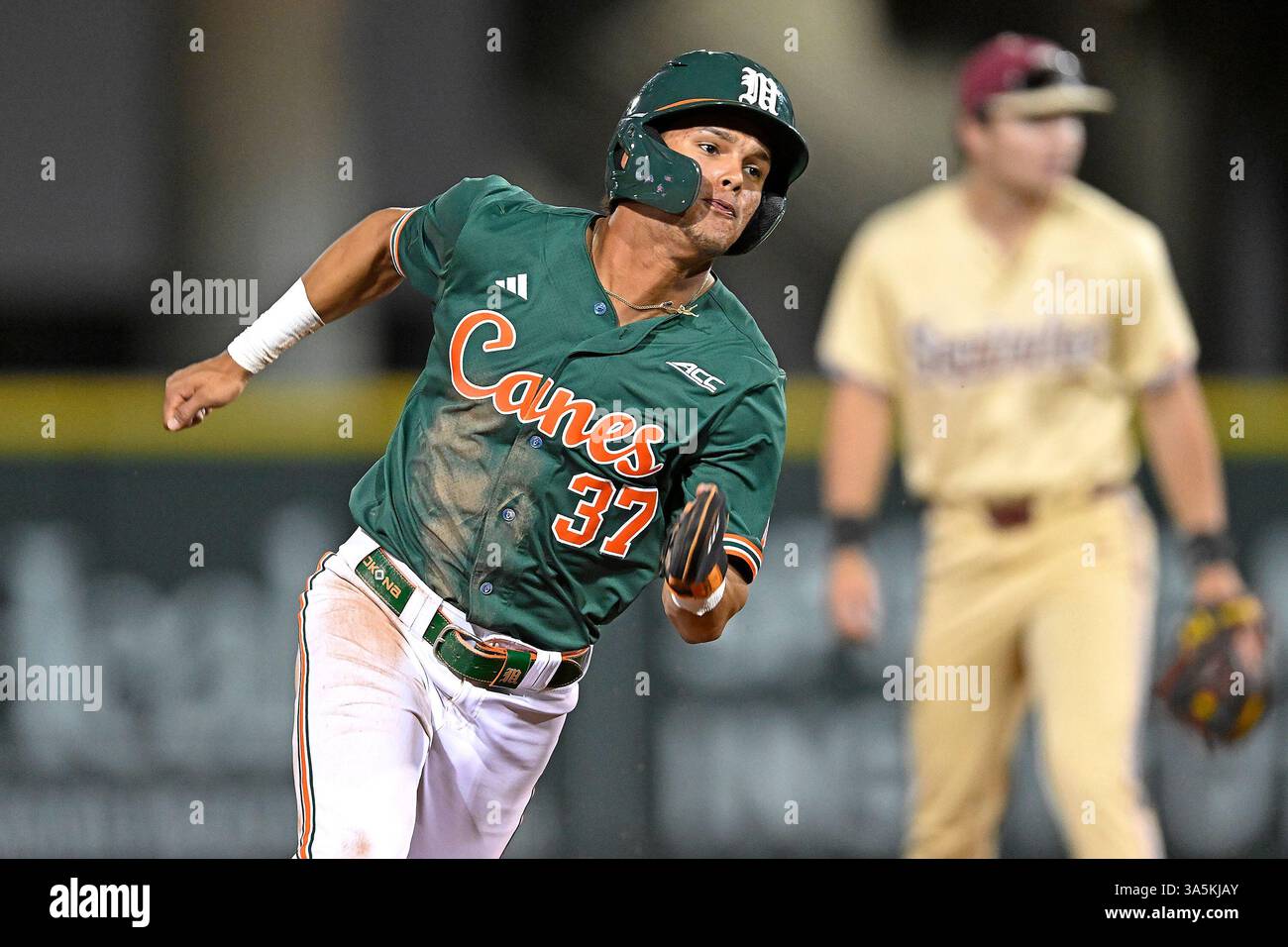 CORAL GABLES, FL - MARCH 22: Miami outfielder Fabio Peralta (37) runs ...