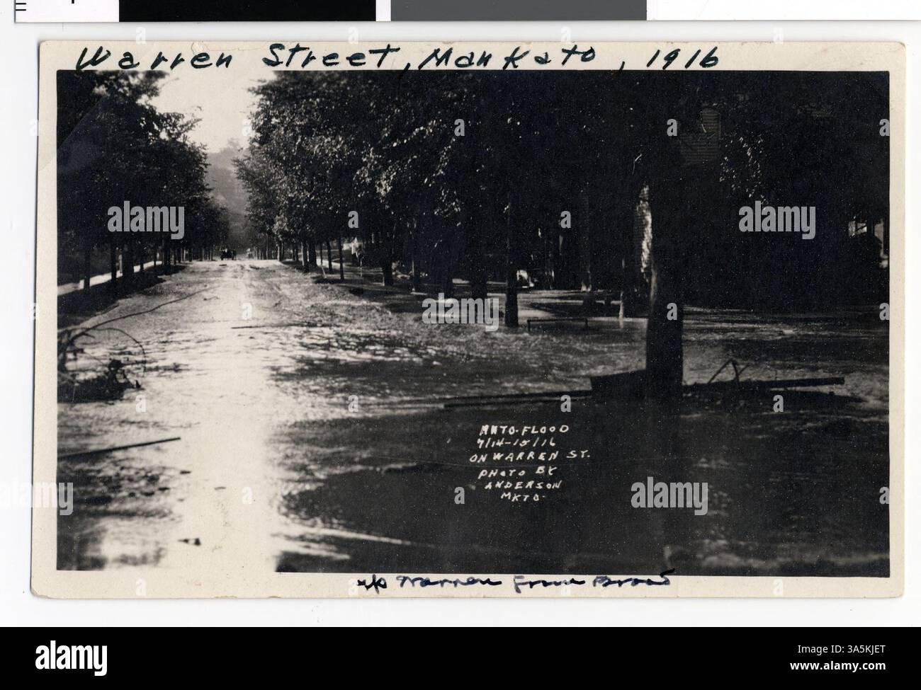 This photograph captures the floodwaters and debris along Warren Street ...