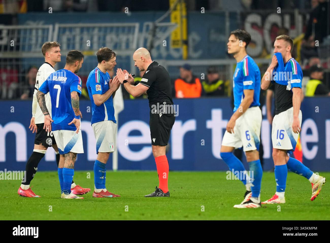 Referee Szymon Marciniak, centre, talks to Italy's Sandro Tonali after ...