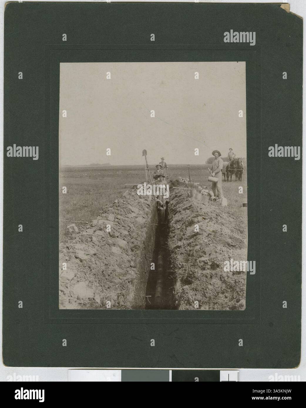 Workers digging an irrigation ditch in Blue Earth County, Minnesota, to ...