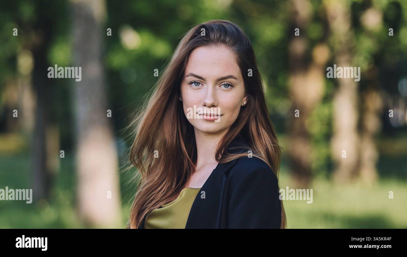 Professional businesswoman standing confidently in urban park, blazer ...