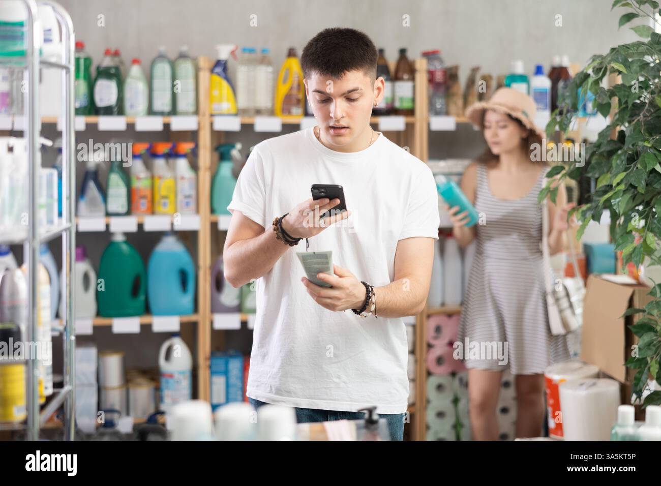 Guy scanning sunscreen packaging barcode Stock Photo - Alamy